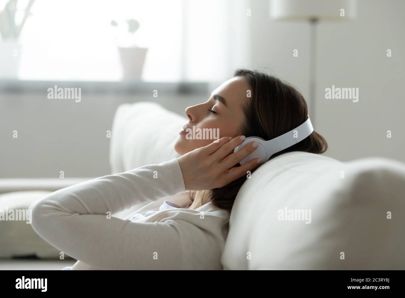 Woman enjoy music listens song through wireless modern headphones Stock ...