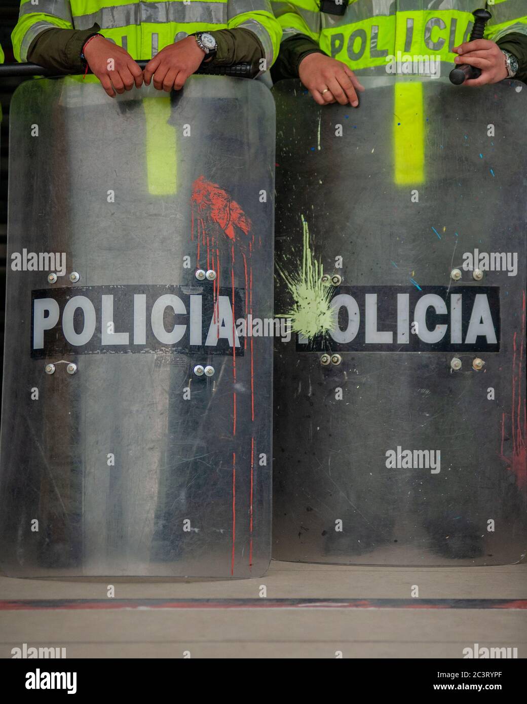 Two police officers riot shields with paint splashes on the 21N Paro ...