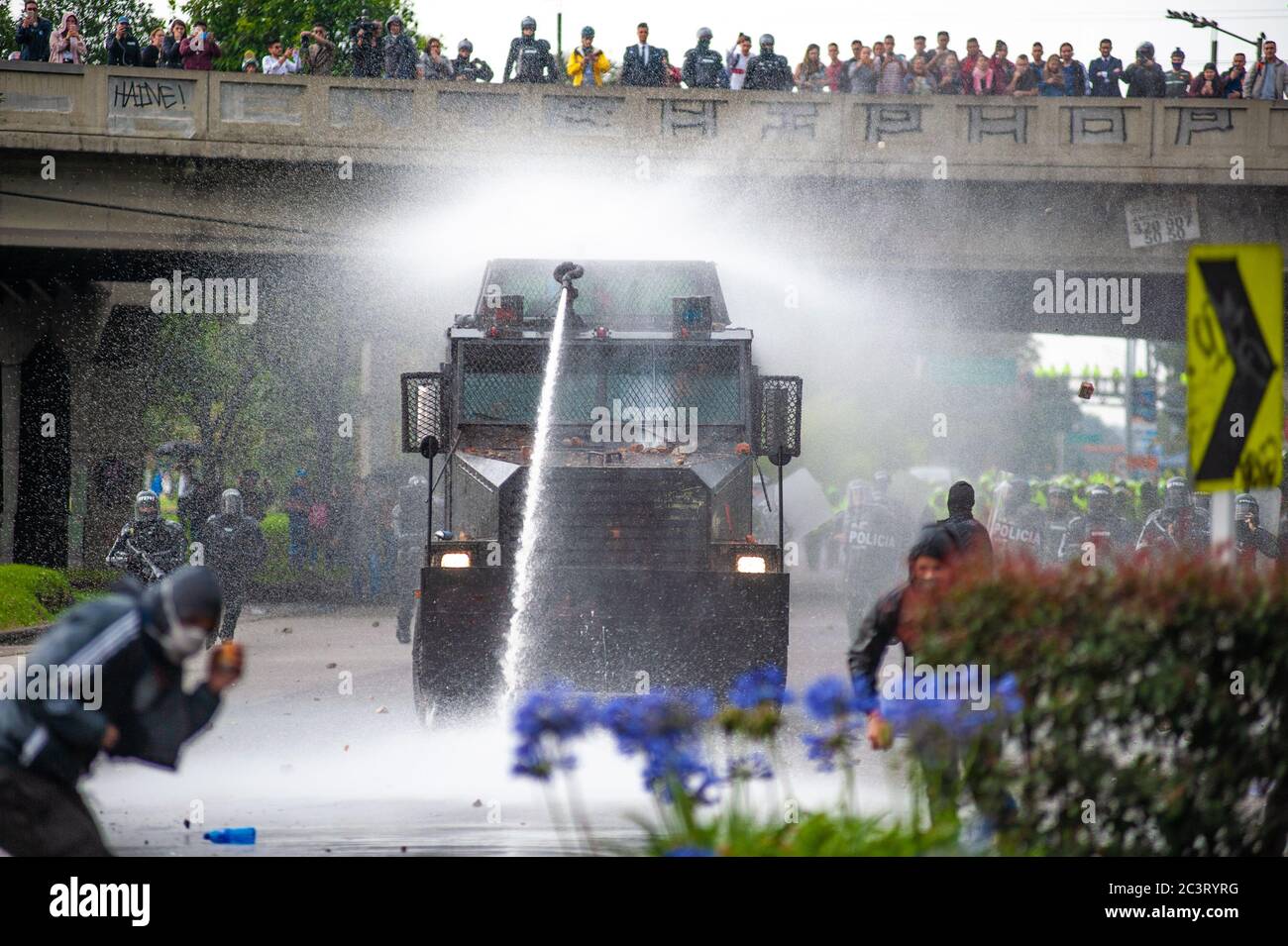 Riot Police water cannon tank hit by rocks and paint while shooting ...