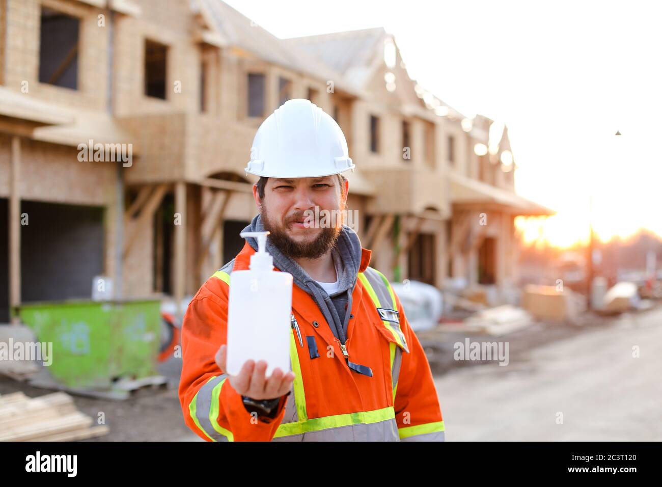 Builder worker giving disinfectant soap at construction site Stock ...