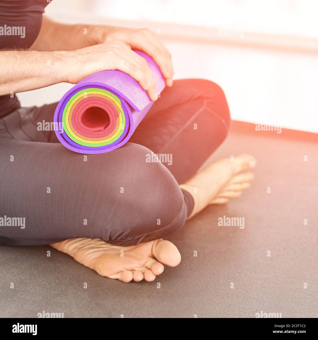 Person holding yoga mat at knee. Sport equipment concept Stock Photo ...