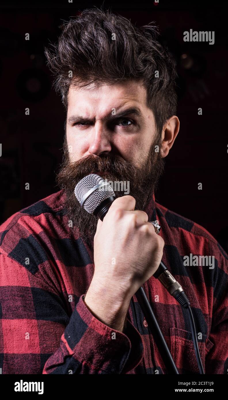 Musician, singer singing in music hall, club. Man with tense strict ...