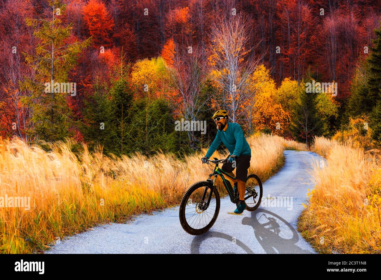 Cycling man riding on bike at sunset mountains forest landscape ...