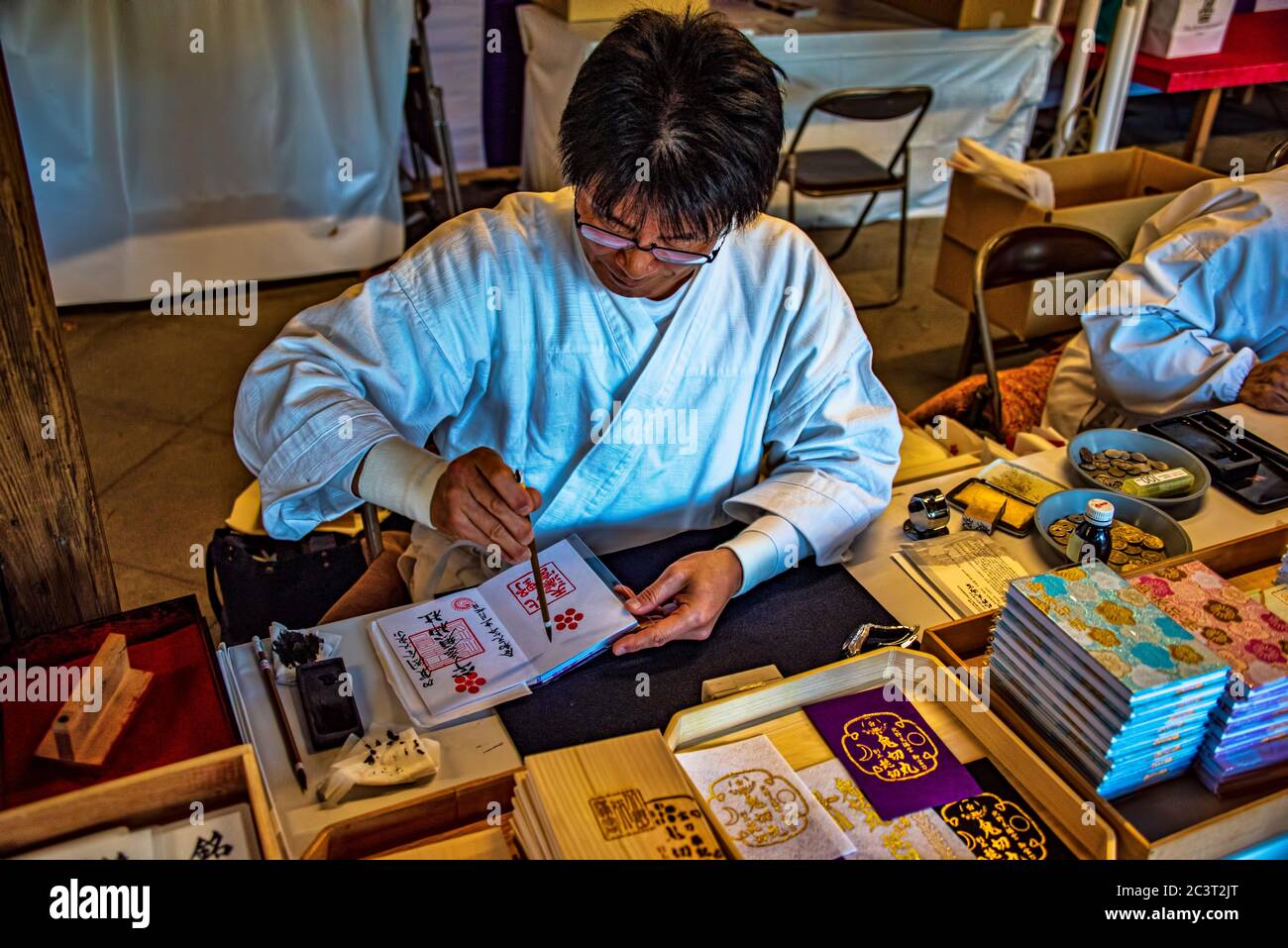 Monk writing goshuin Kitano Tenmangu shinto shrine, Kyoto, Japan Stock ...