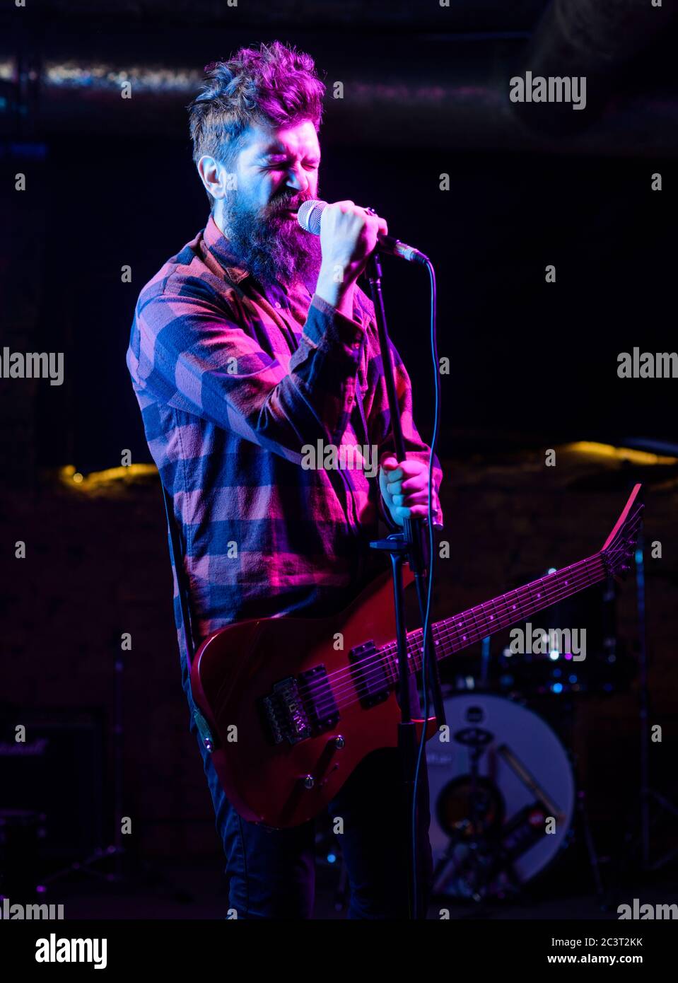 Frontman concept. Young rock musician, singer. Musician with beard play ...