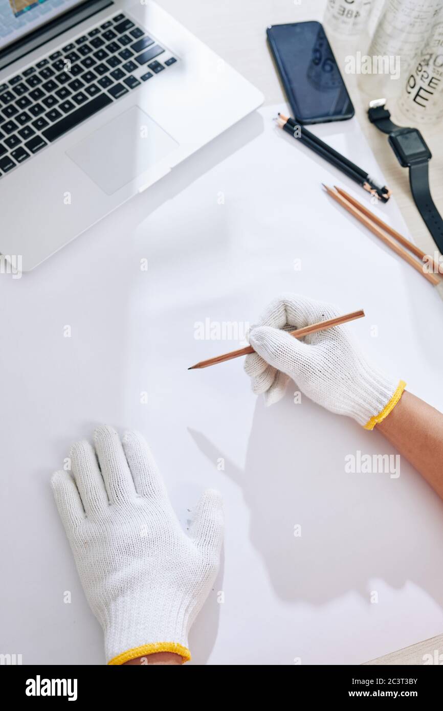 Construction engineer drawing plan of building on blank sheet in front ...