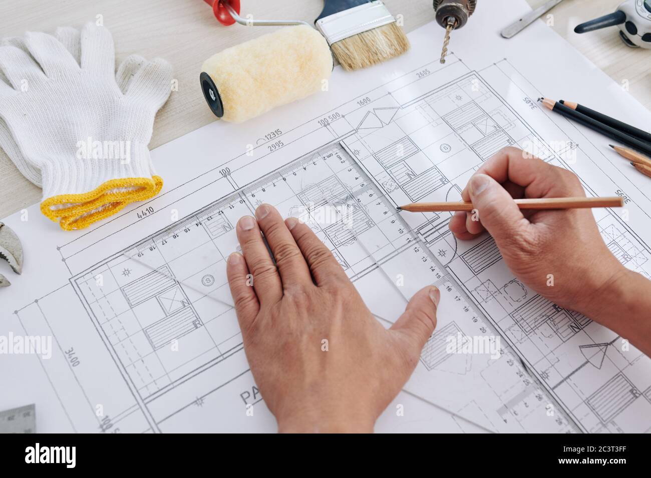 Close-up image of construction engineer finishing blueprint of house ...