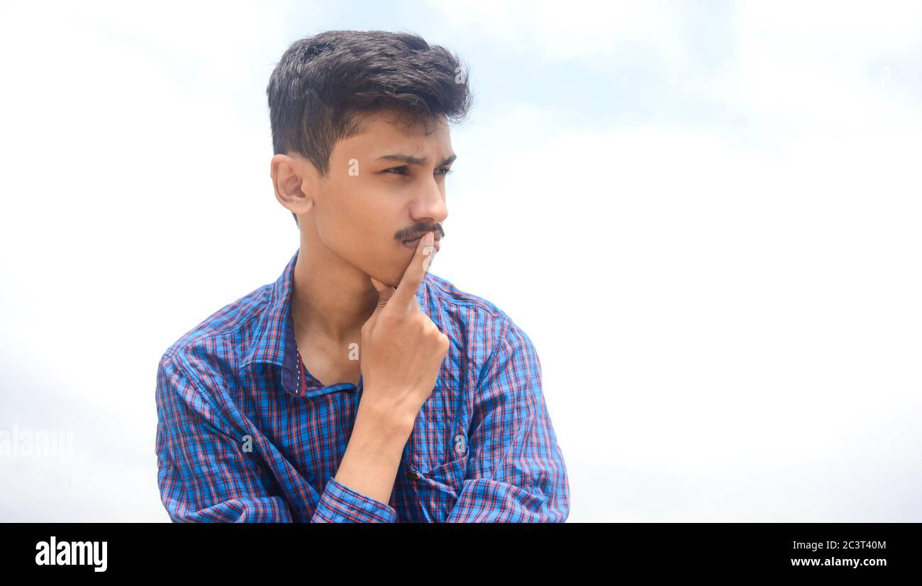 Portrait of handsome young teen man in deep thinking about his future ...