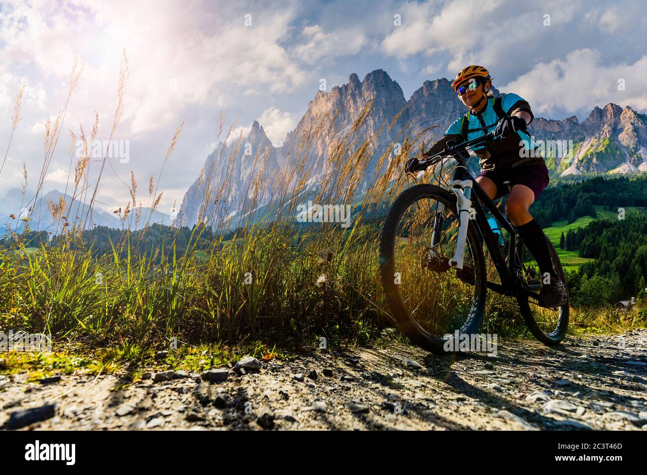Cycling outdoor adventure in Dolomites. Cycling woman in Dolomites ...