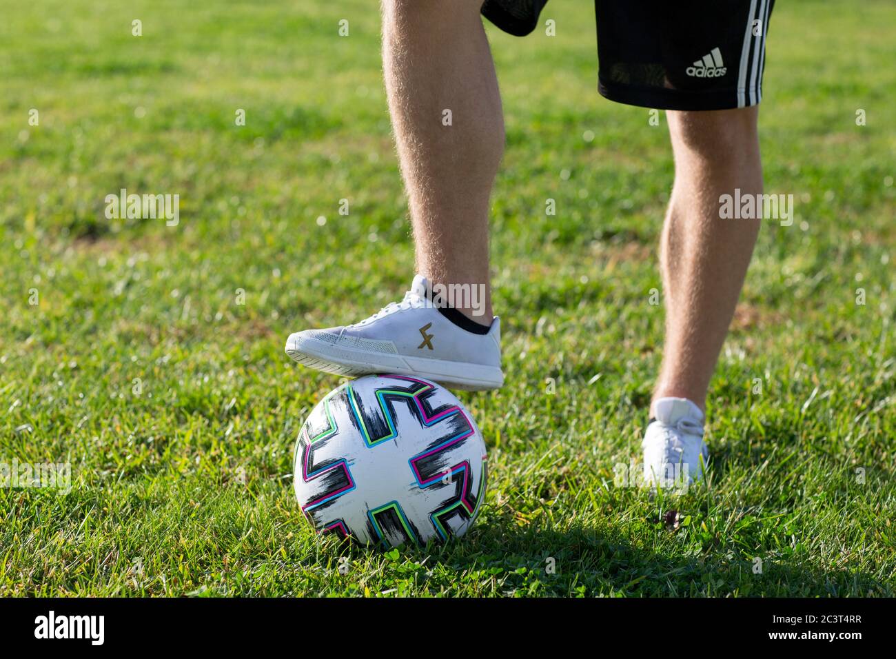 Soccer player is standing with a ball under his foot. Football concept ...