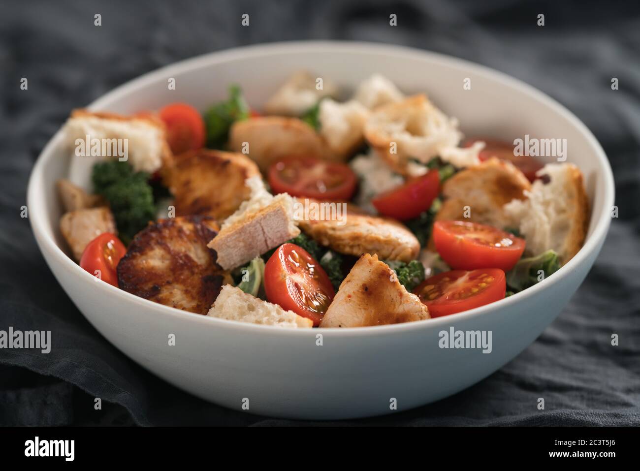 Caesar salad alternative with kale and turkey in white bowl Stock Photo ...