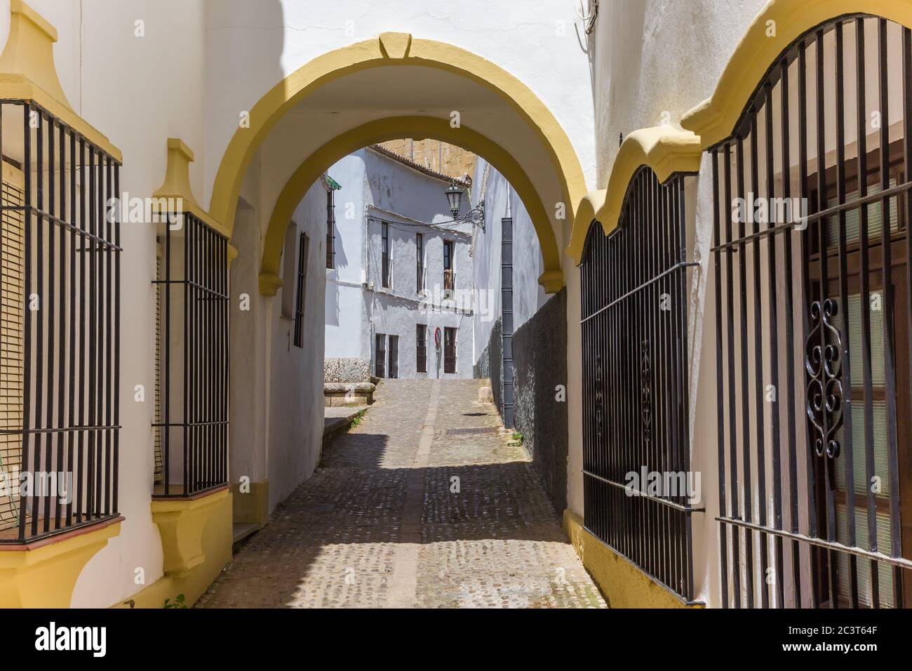Arch in a historic narrow street in Ronda, Spain Stock Photo - Alamy