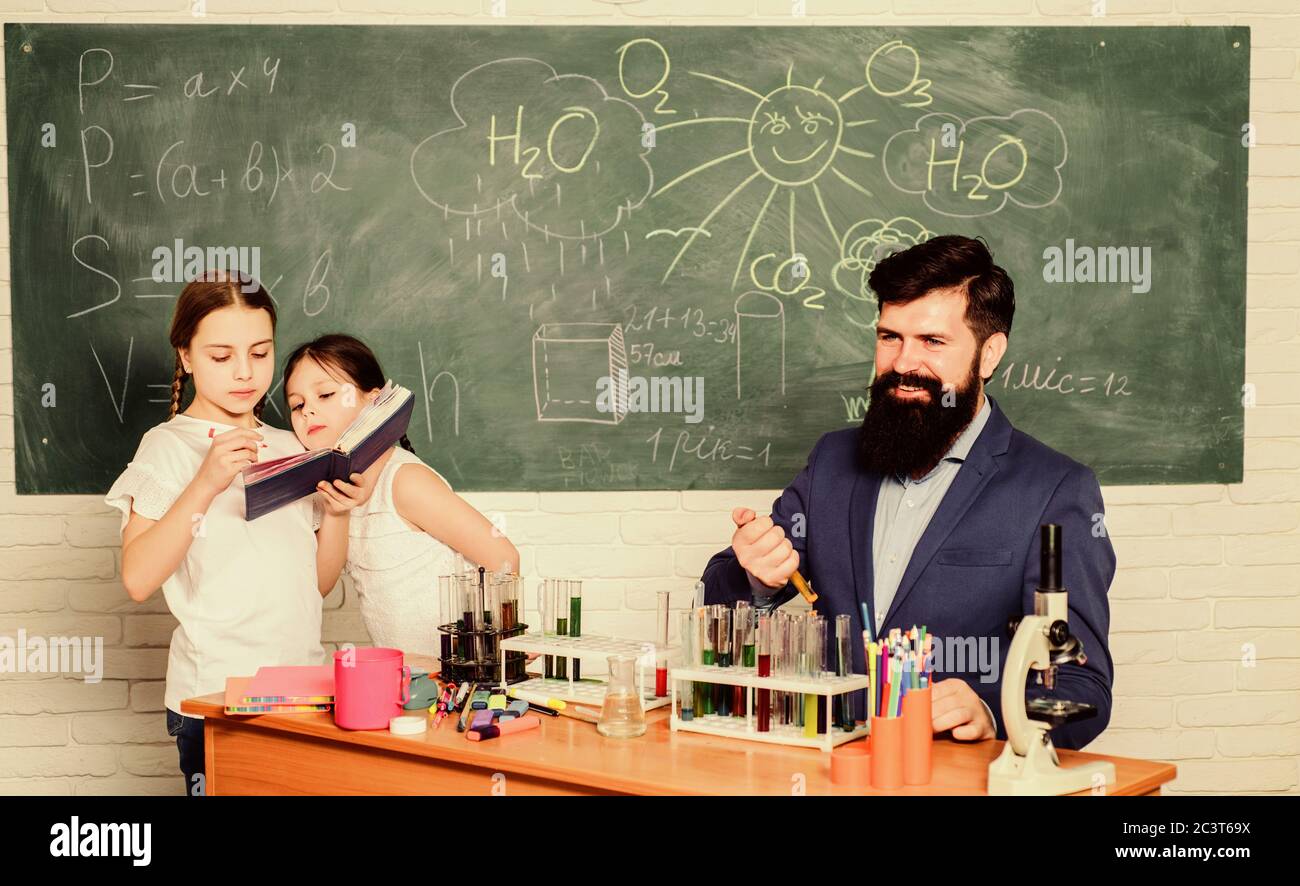 School club education. Teacher and pupils test tubes in classroom ...