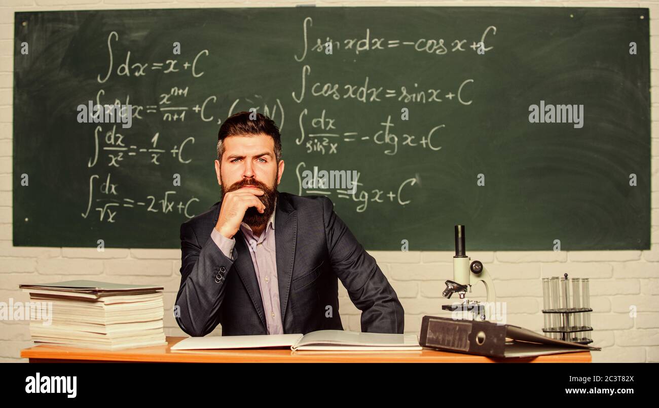 Thinking on serious problem. Serious teacher touching beard by hand ...