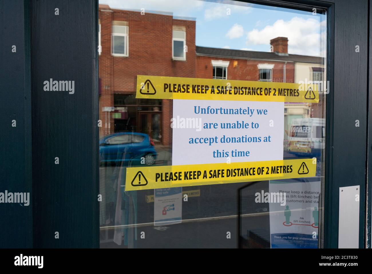 Poster in charity shop window hi-res stock photography and images - Alamy