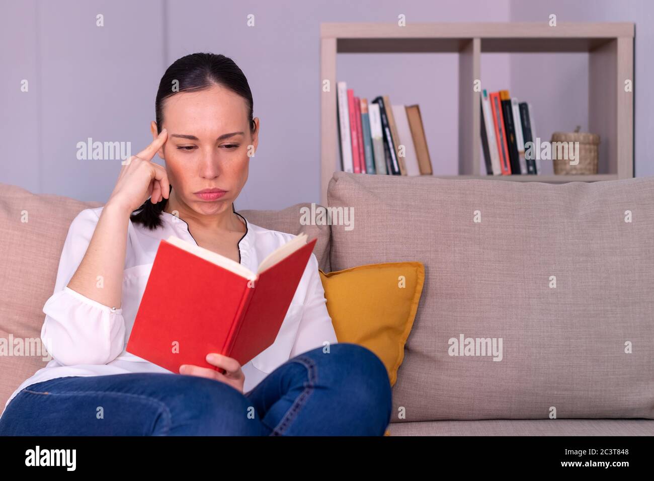 Sitting bored on sofa hi-res stock photography and images - Alamy