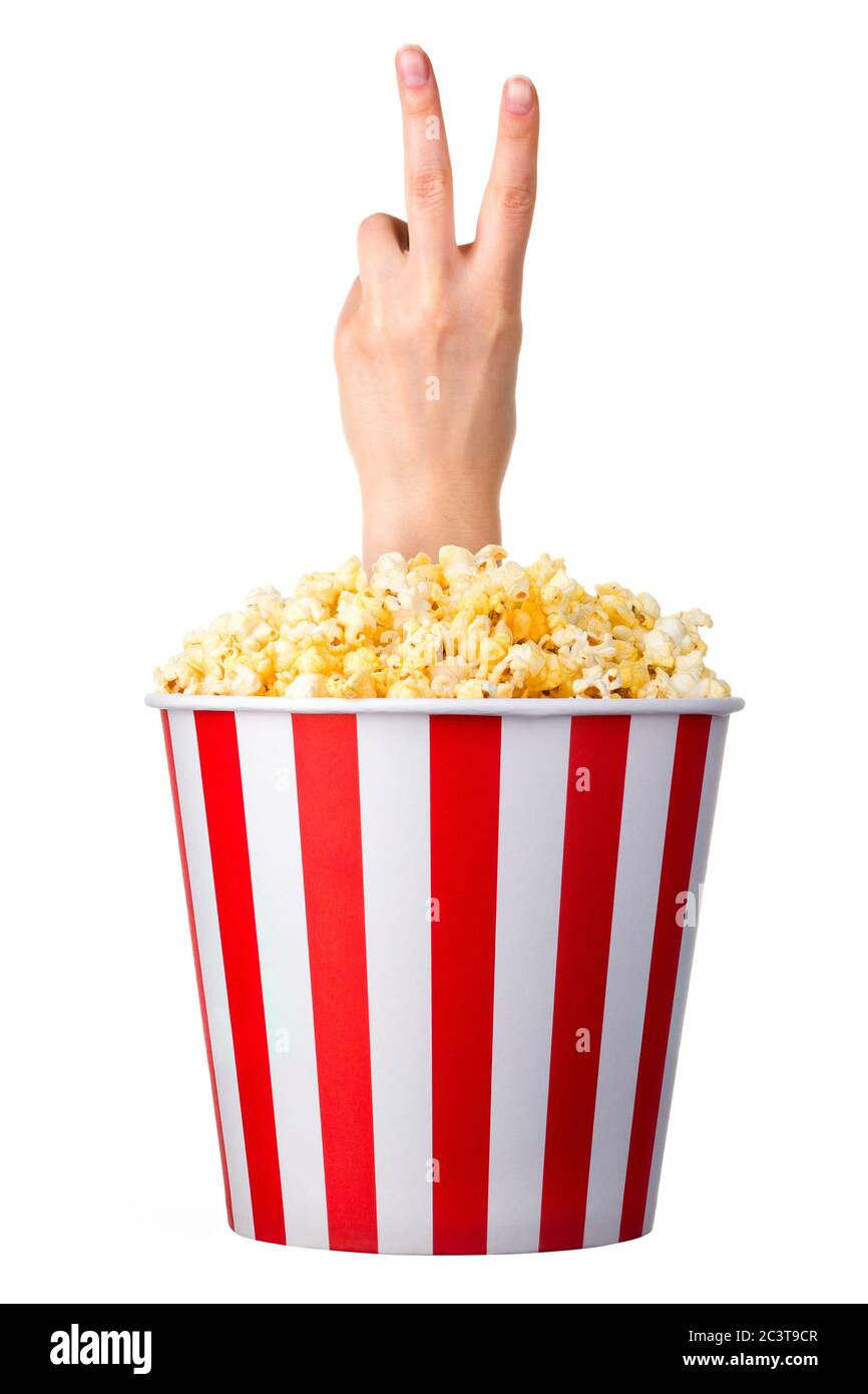 Female hand sticks out of a bucket with popcorn isolated on white ...
