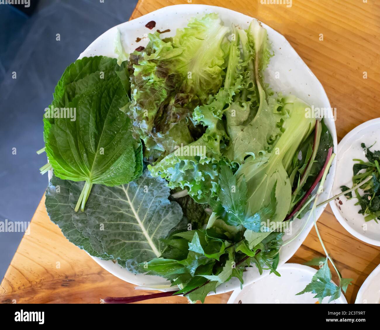 vegetable set for ssam. rice and condiments wrapped in leaves of ...