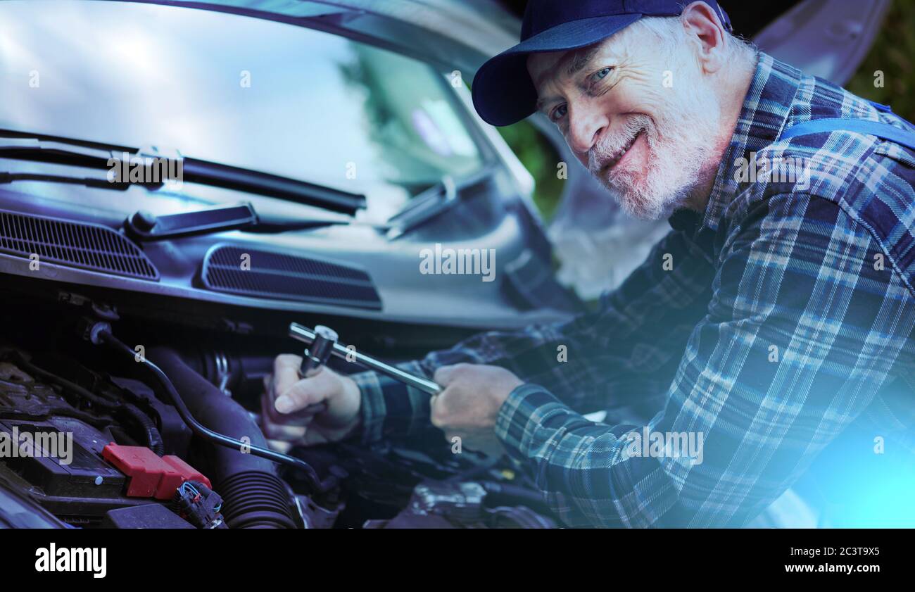 Car mechanic repairing a car engine; light effect Stock Photo - Alamy