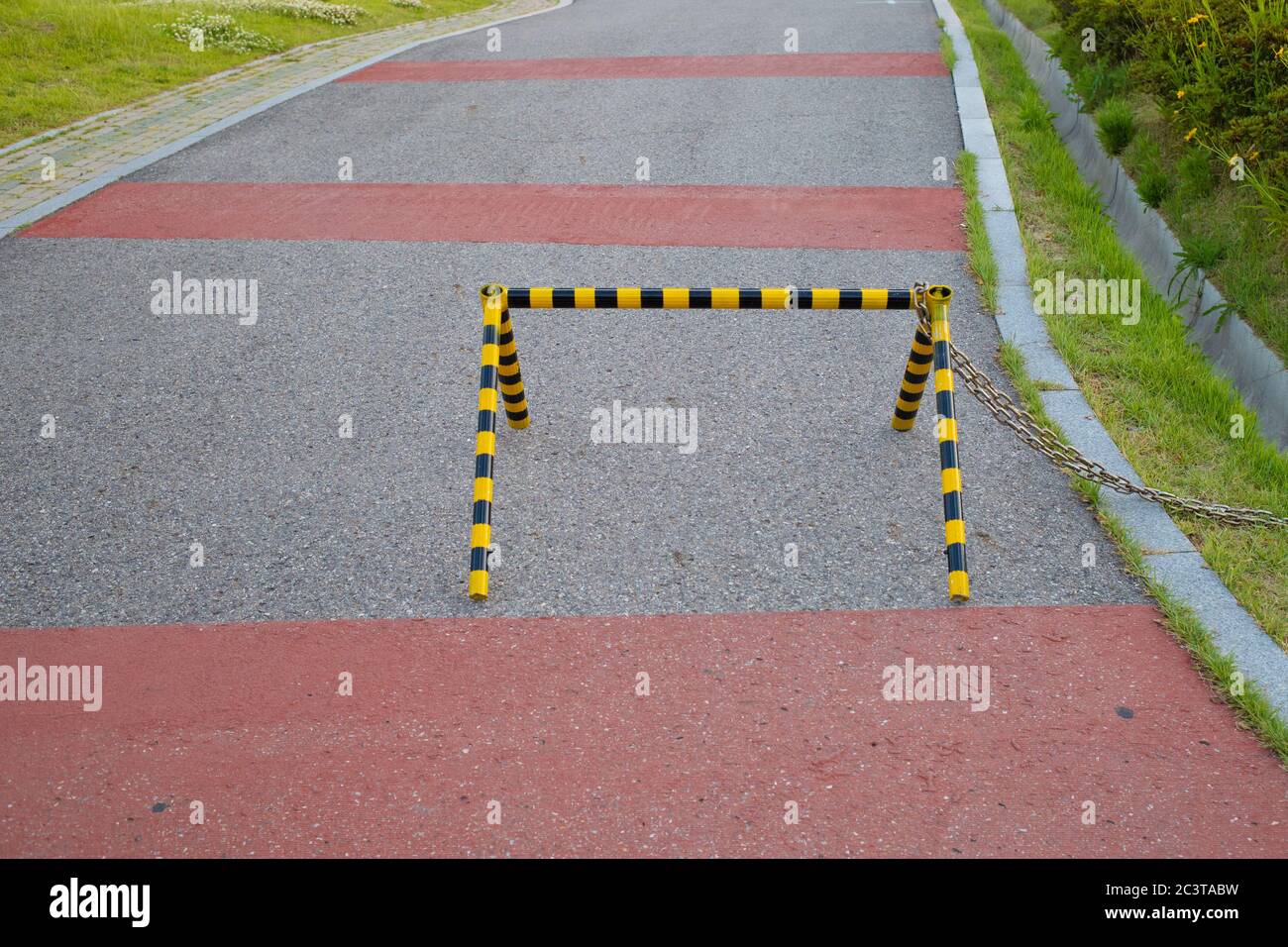 yellow barricade for vehicle entry and exit Stock Photo - Alamy