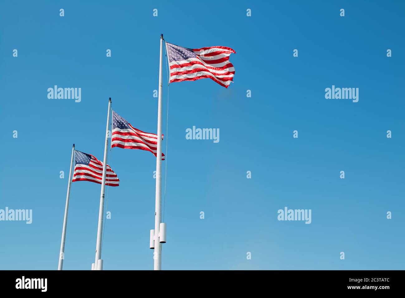 Three USA flags in a row Stock Photo - Alamy