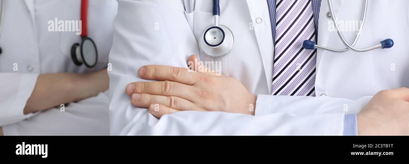 Doctors man and woman crossed arms over chest Stock Photo - Alamy