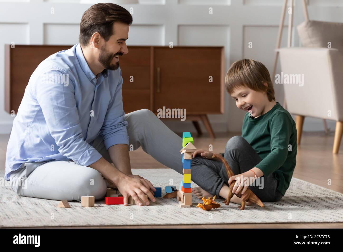 Happy father and little son playing with toys together Stock Photo - Alamy