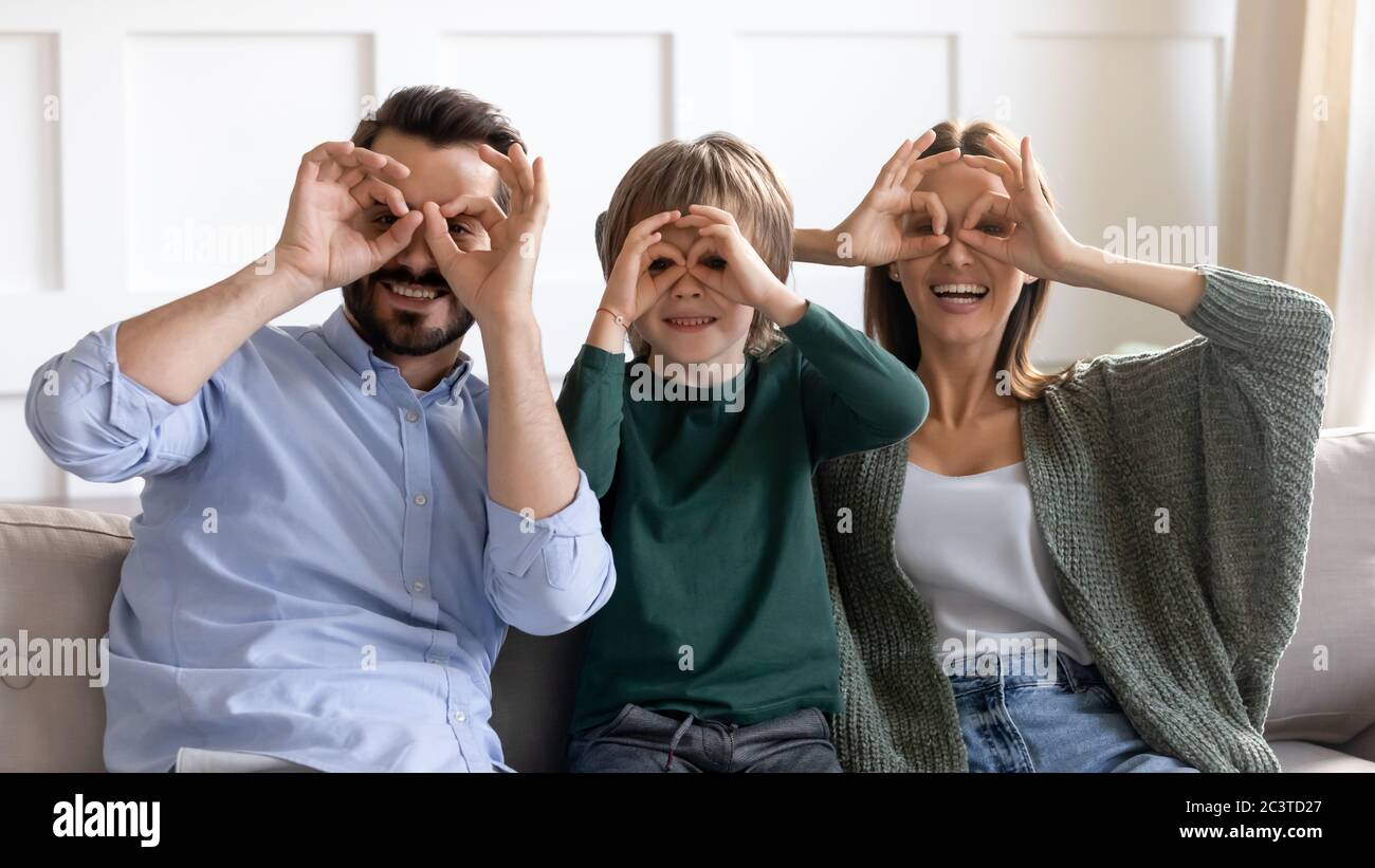 Head shot portrait happy parent with son making funny faces Stock Photo ...
