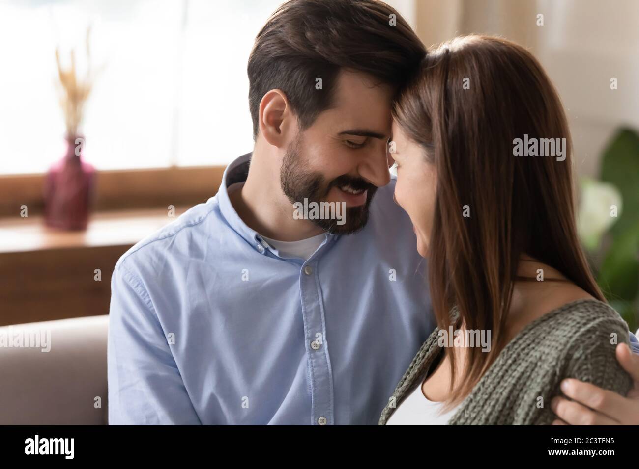 Close up young loving couple touching foreheads, enjoying tender moment ...