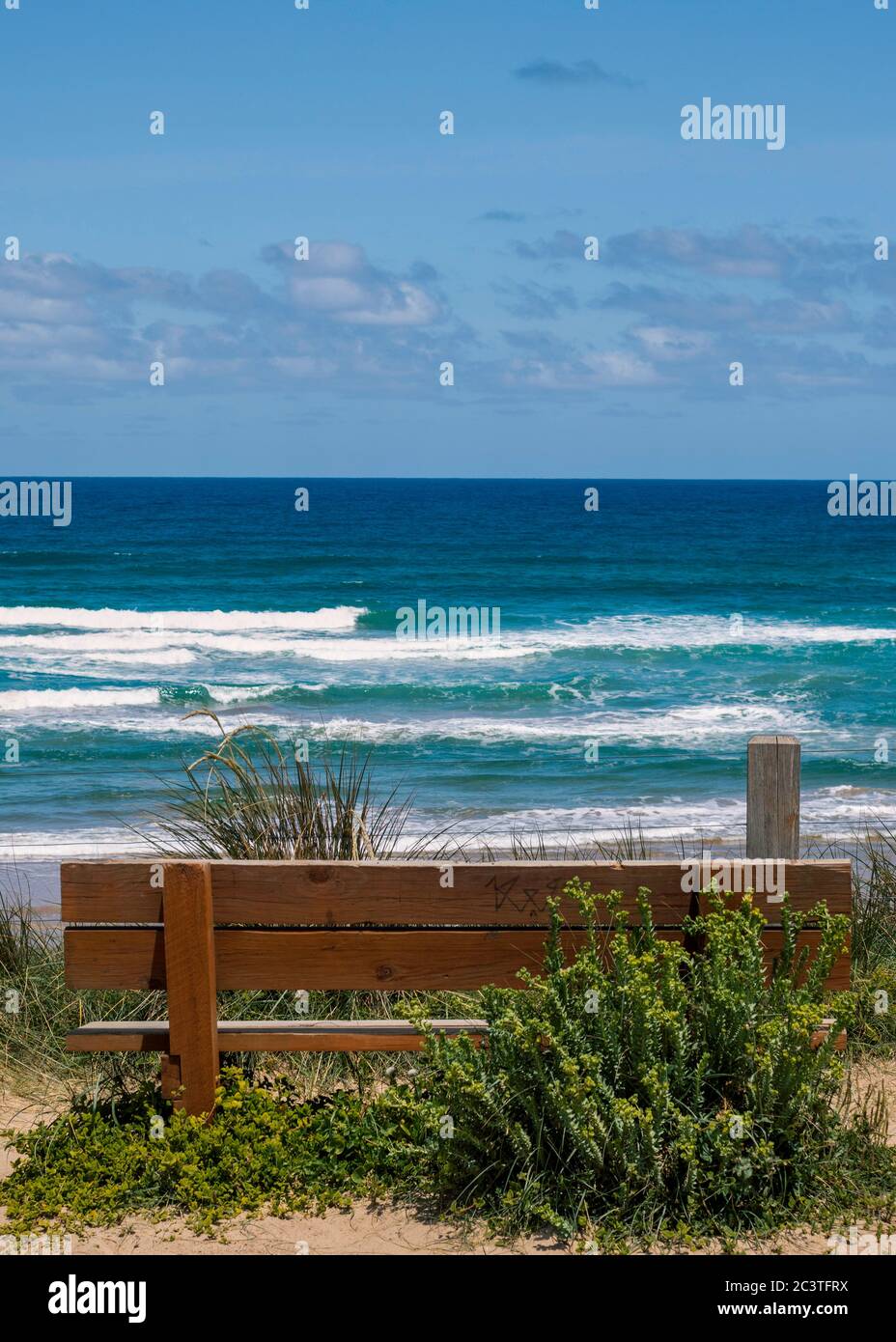 Outdoor bench looking out into the ocean waves Stock Photo - Alamy