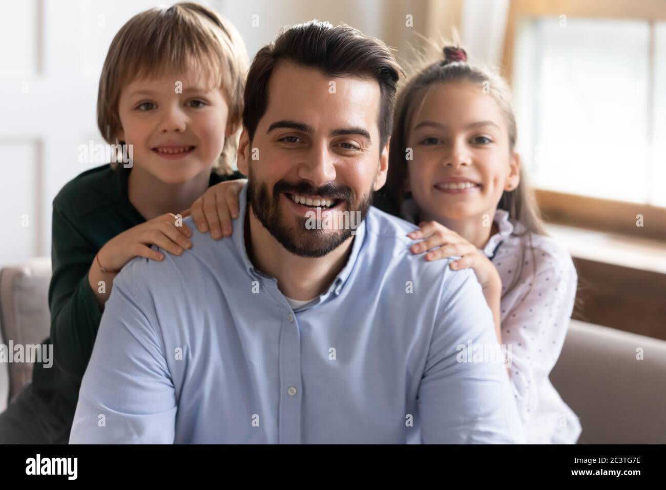 Head shot portrait children hugging smiling father from back Stock ...