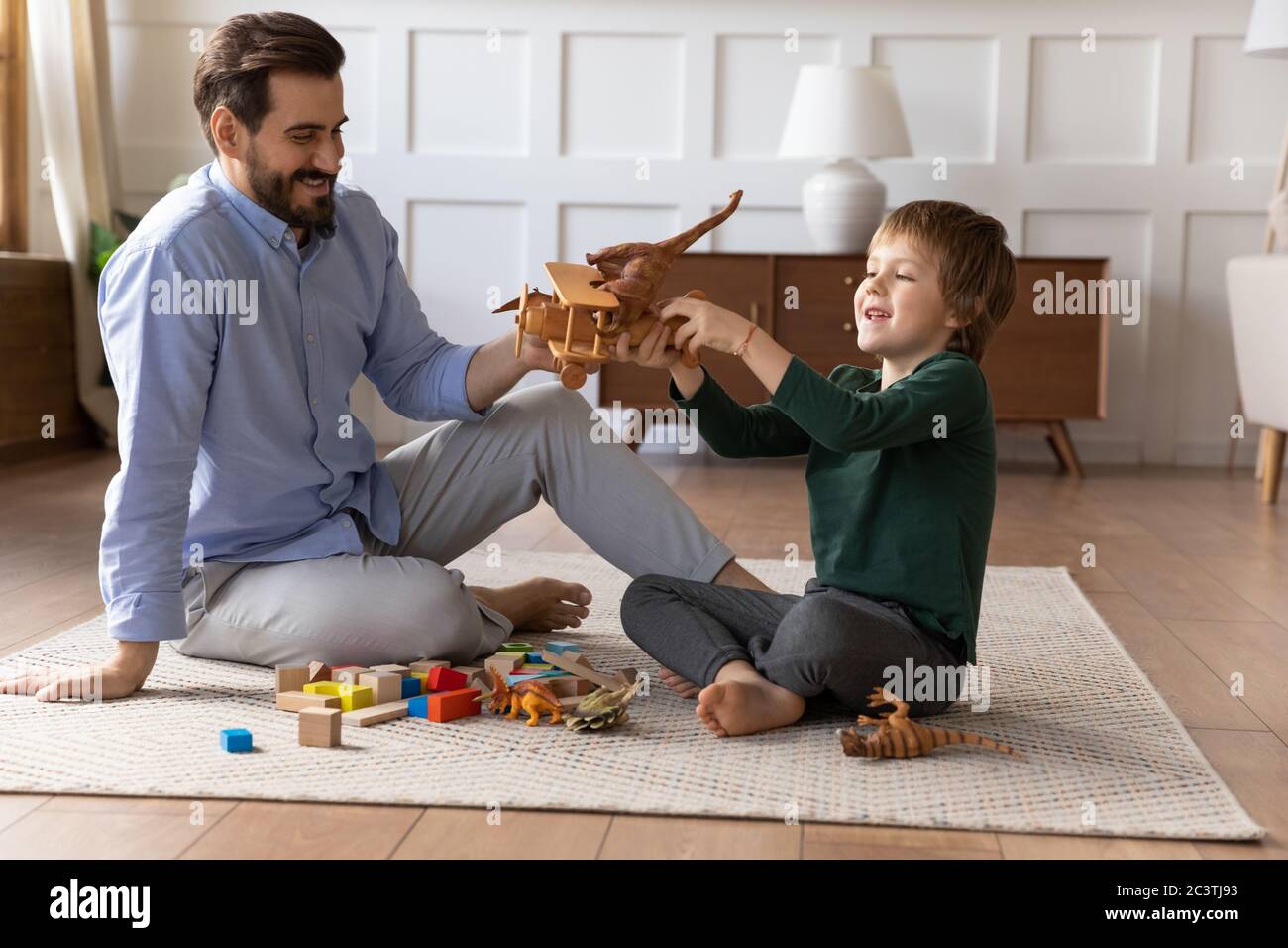 Happy father and little son having fun with toys together Stock Photo ...