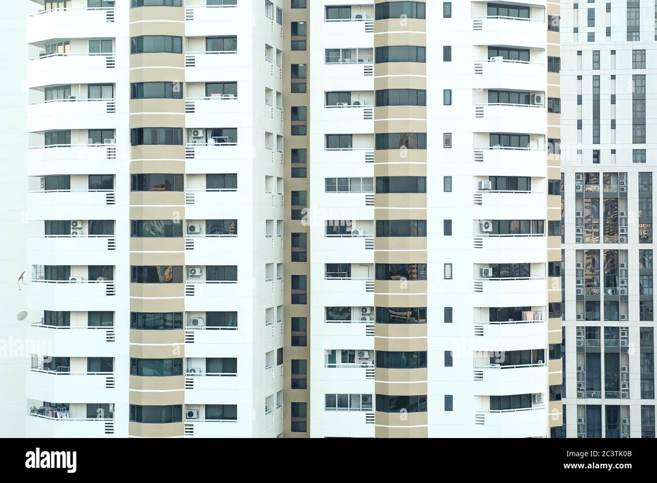 Tall, bright building with balconies and tinted windows Stock Photo - Alamy