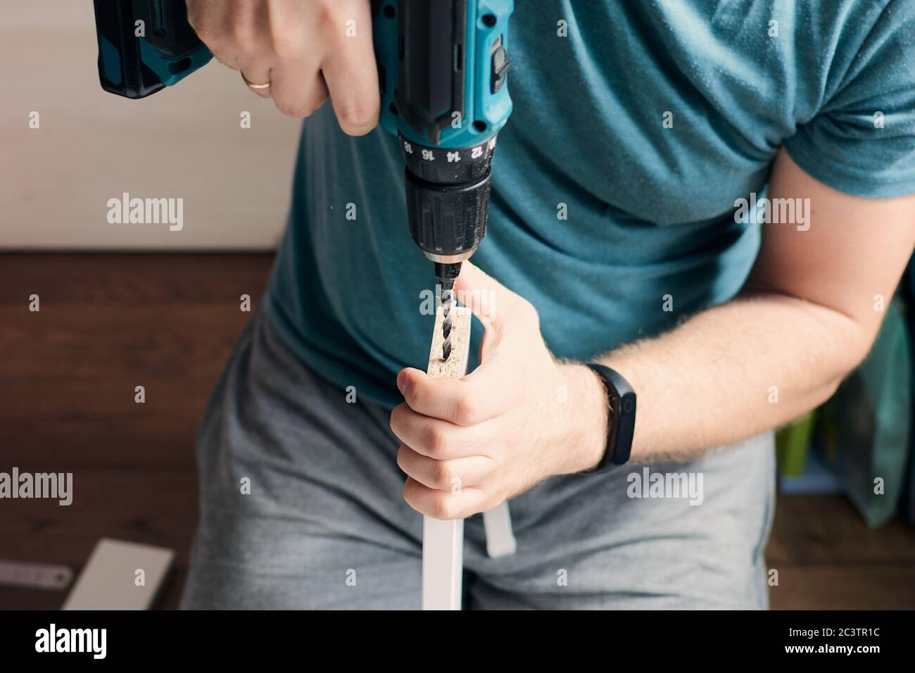 Man doing renovation work at home, drilling with a screwdriver. Group ...