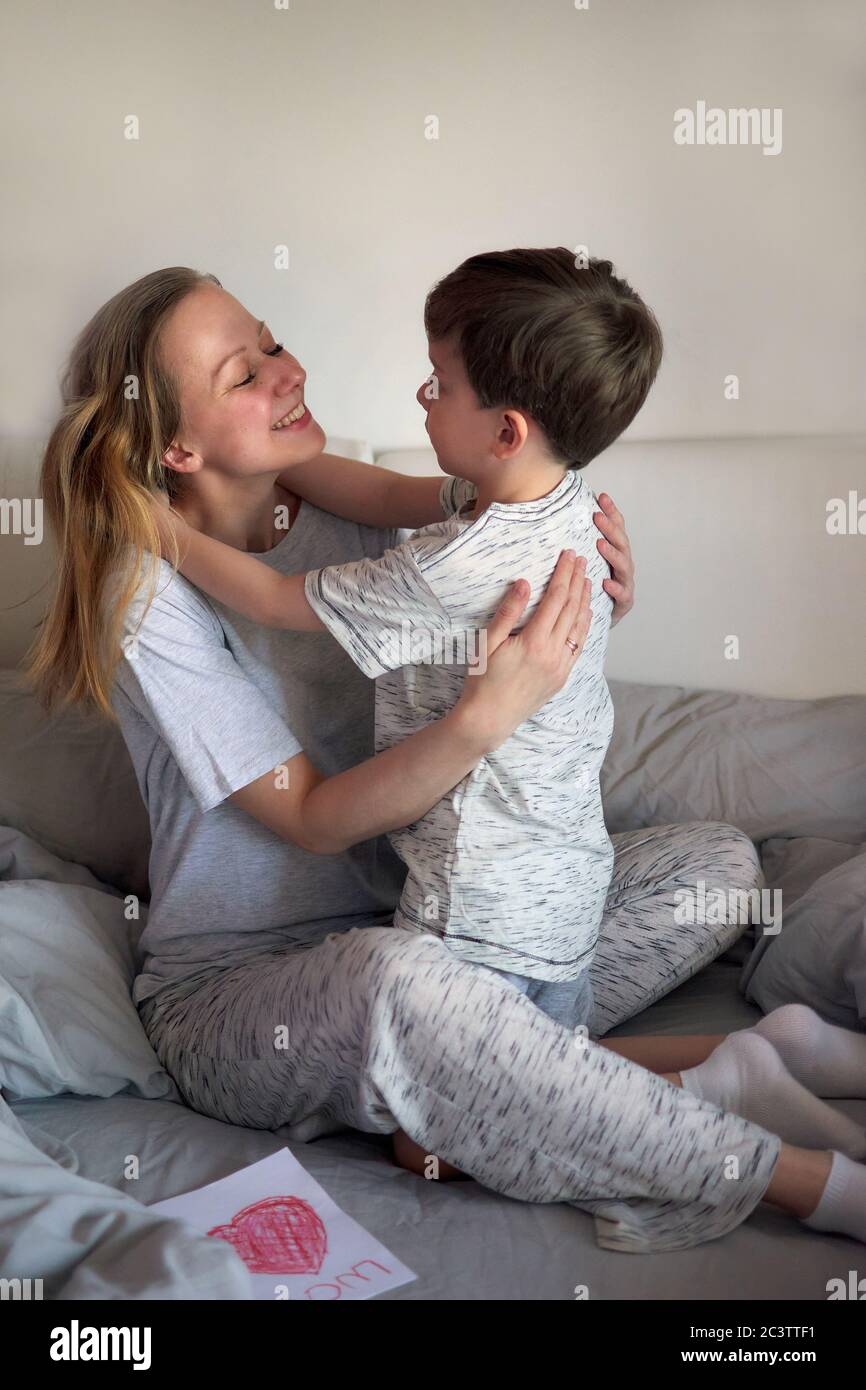 Happy mother's day. Child boy congratulates mom and gives her flowers ...