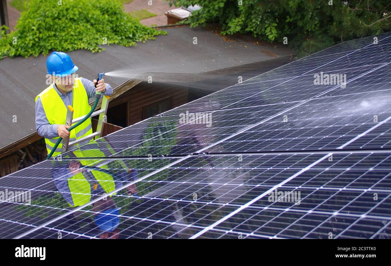 Solar panel cleaning. Maintenance of renewable energy in a private home ...