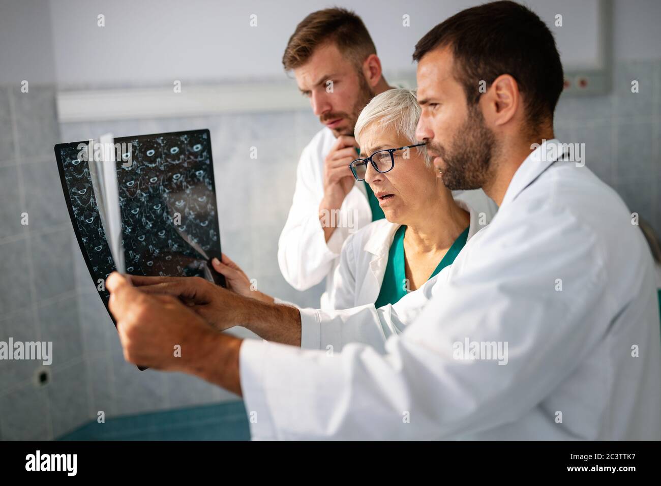 Group of doctor looking at ct scan at hospital to make diagnosis Stock ...