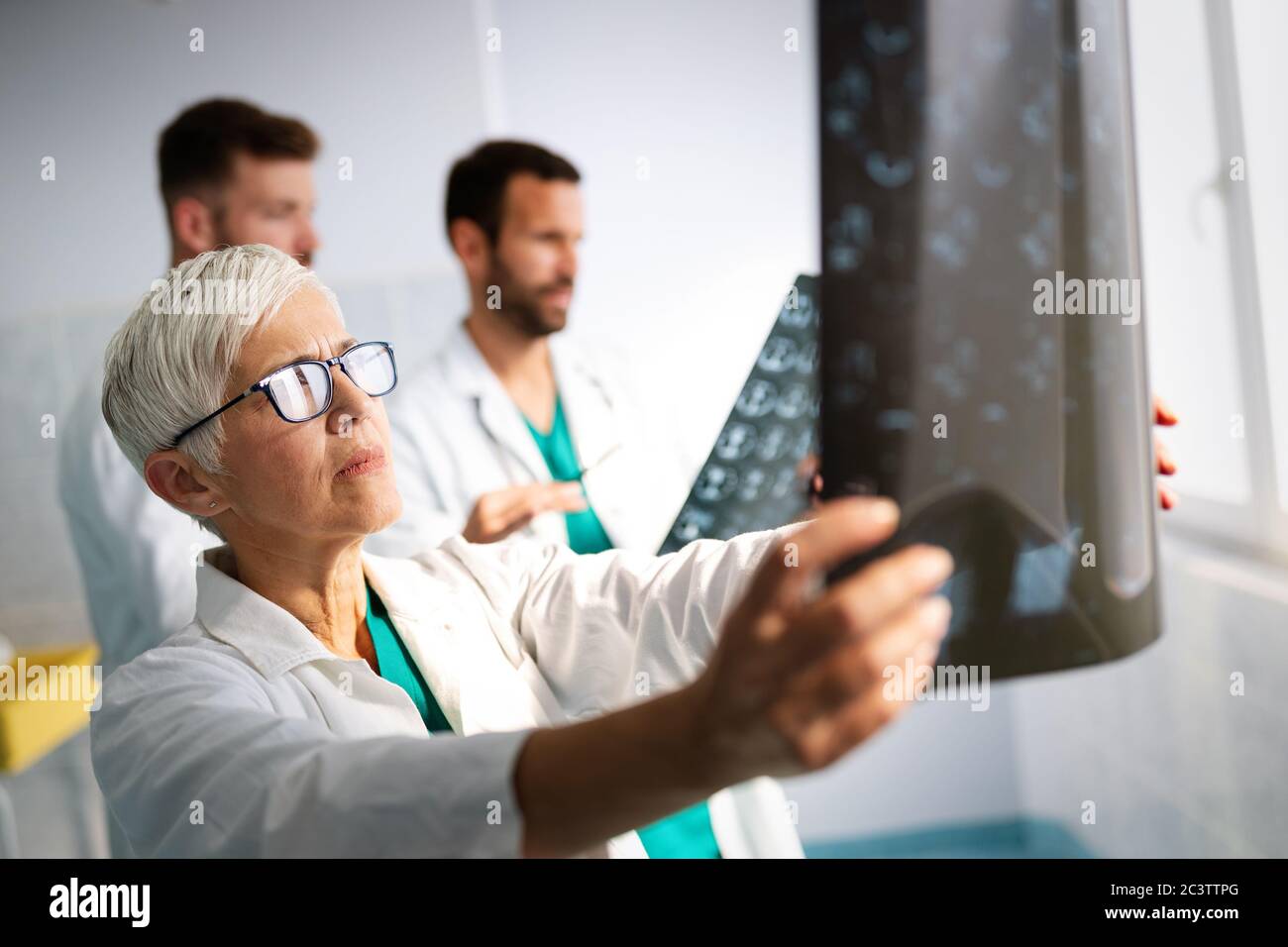 Group of doctor looking at ct scan at hospital to make diagnosis Stock ...
