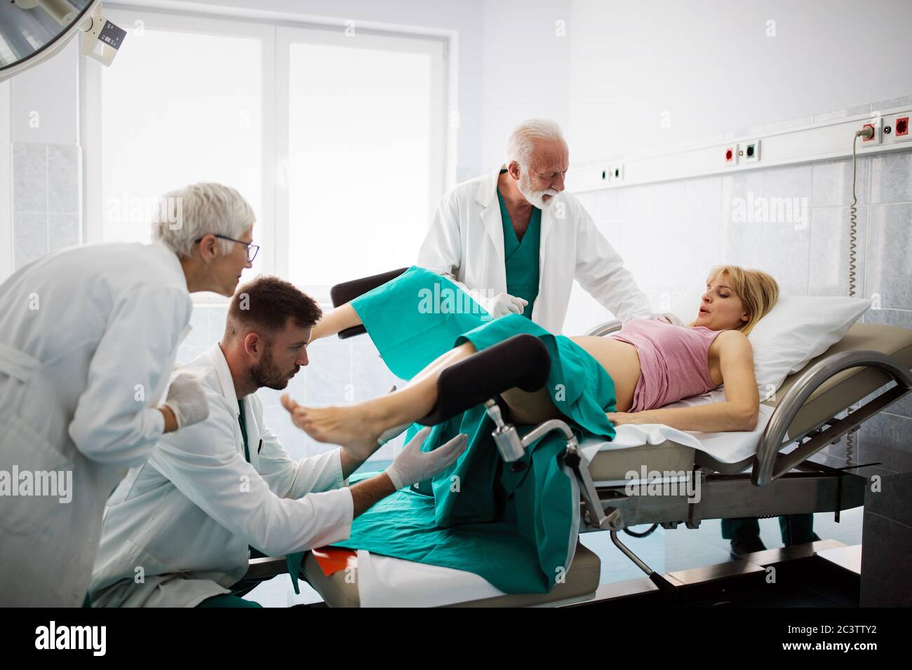 In The Hospital Woman In Labor Pushes To Give Birth Obstetricians