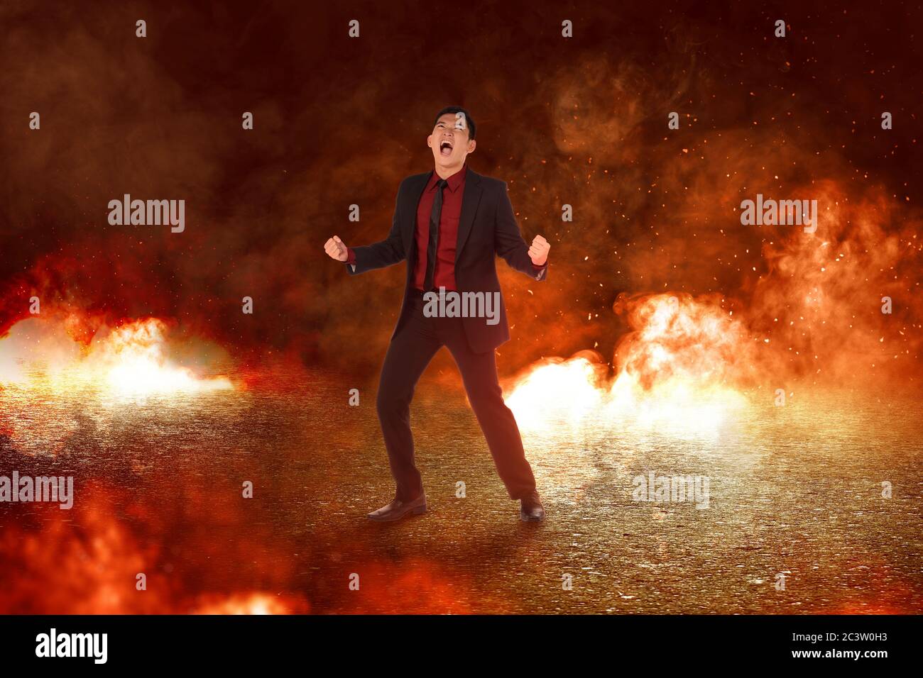 Asian businessman standing with emotional expression with an explosion ...