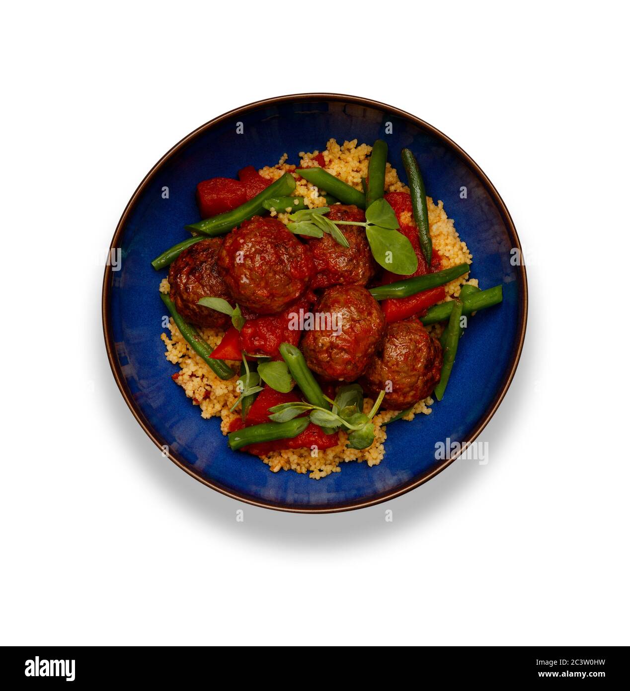 A delicious bowl of chipolte meat balls, couscous and vegetables, in a ...