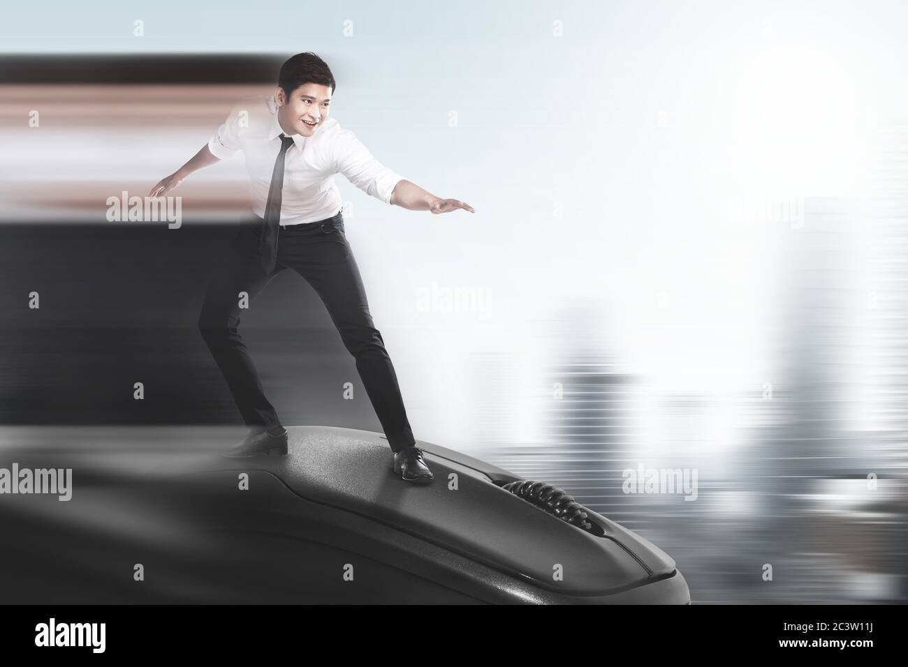 Asian businessman standing on the mouse with blurred background Stock ...