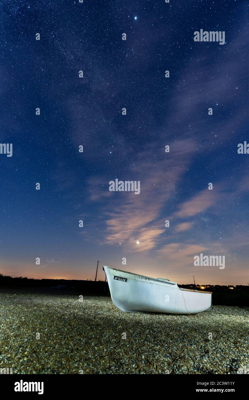 The Milky Way and a boat on a shingle beach, United Kingdom Stock Photo ...