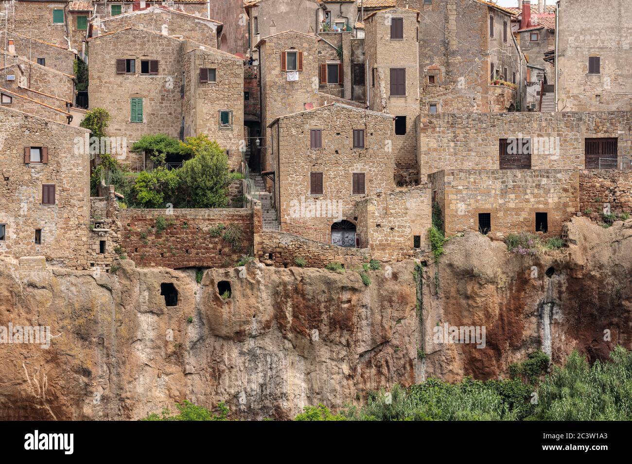 The medieval hill town of Pitigliano built on a tuff rock cliff ...