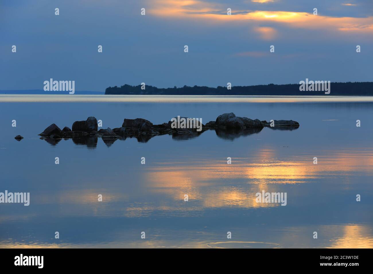 quiet landscape with stones in river on sunset background Stock Photo ...