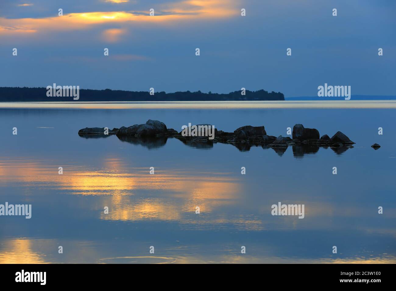 quiet landscape with stones in river on sunset background Stock Photo ...