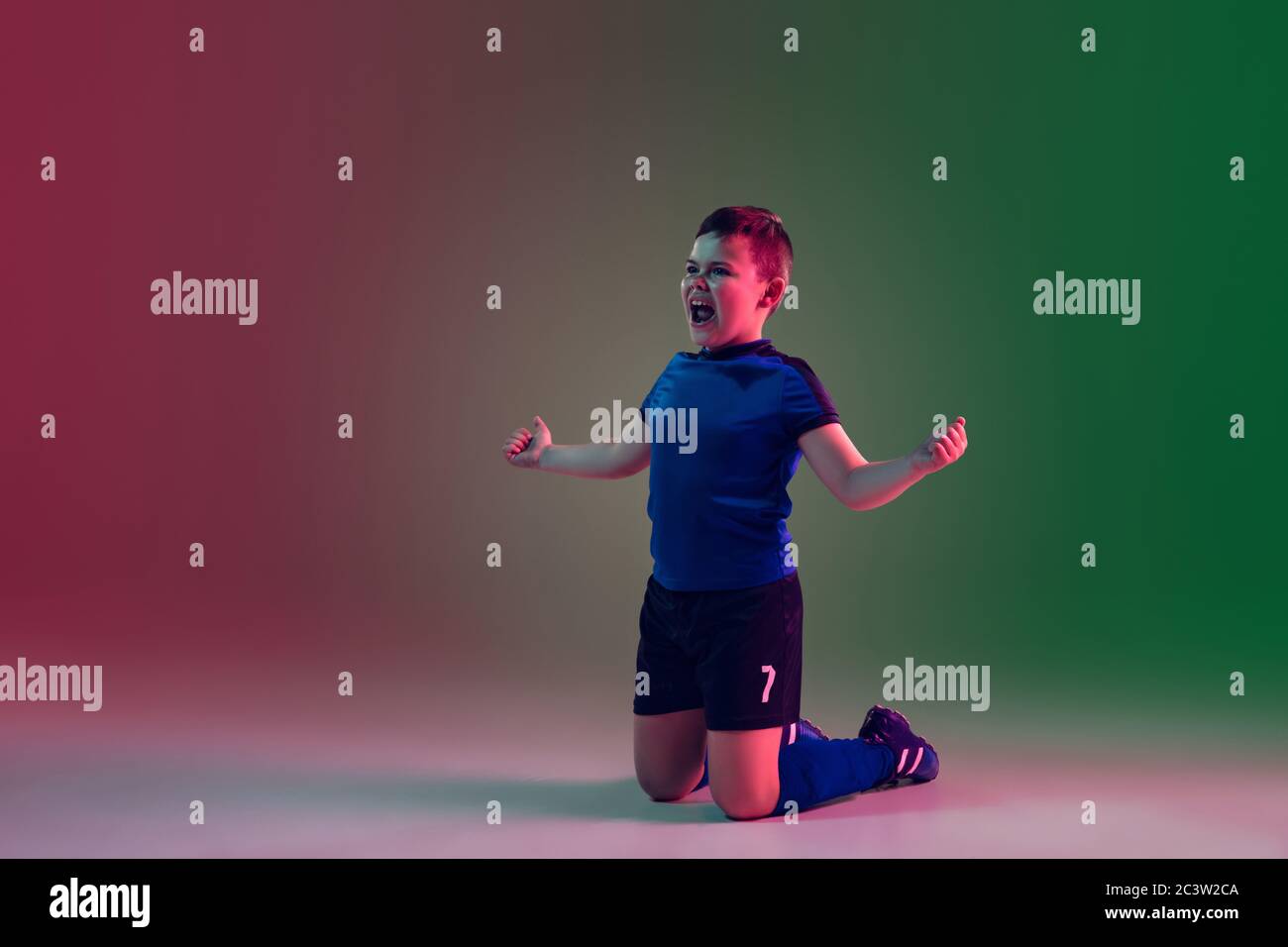 Winning, goal, screaming. Teen male football player on gradient ...