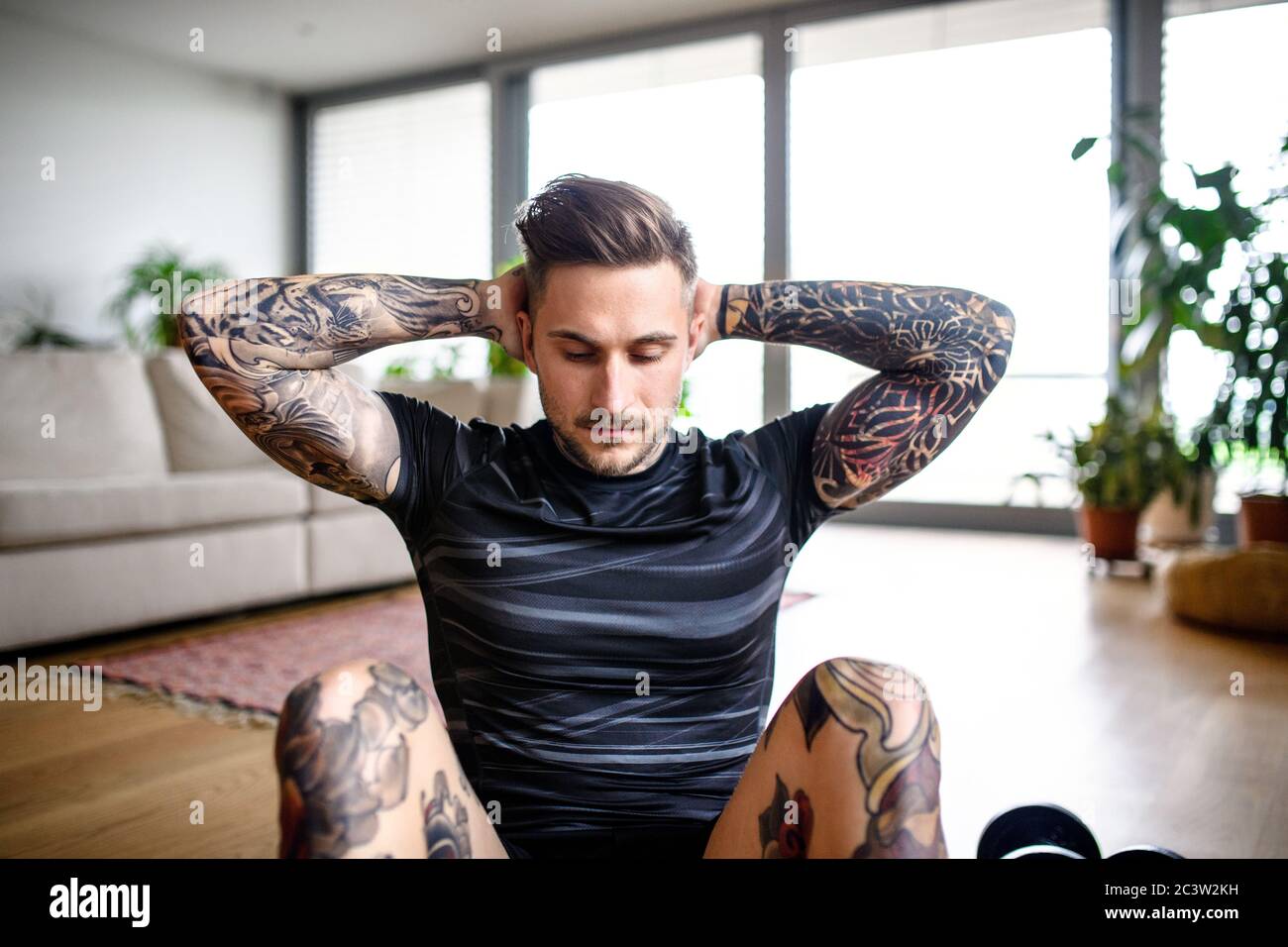 Front view portrait of man doing workout exercise indoors at home Stock ...