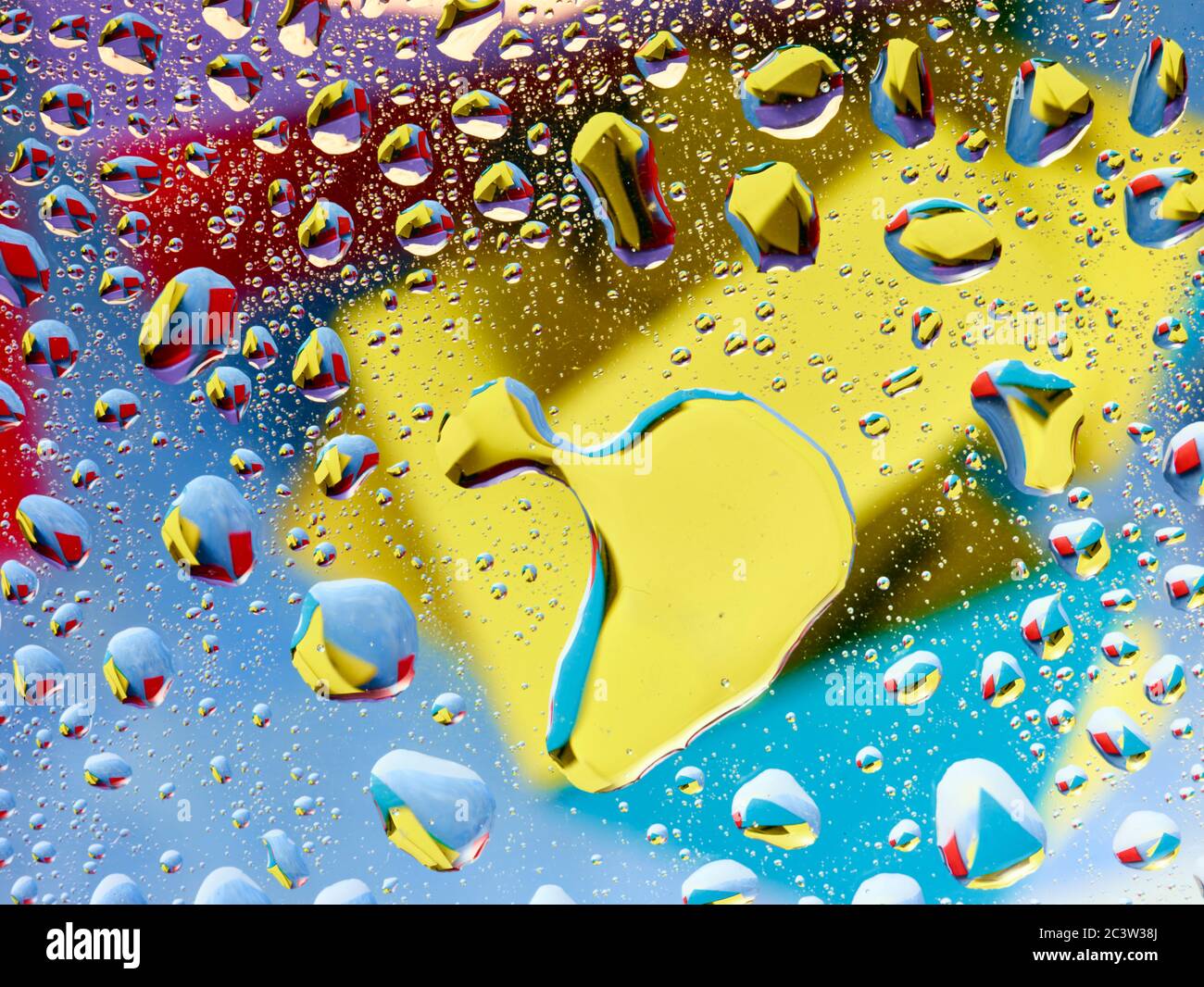 Colourful water drops, droplets, on a hard surface showing abstraction ...