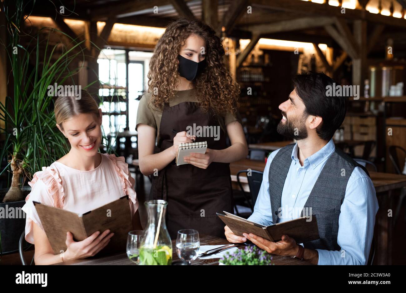 Young couple sitting inside restaurant hi-res stock photography and ...